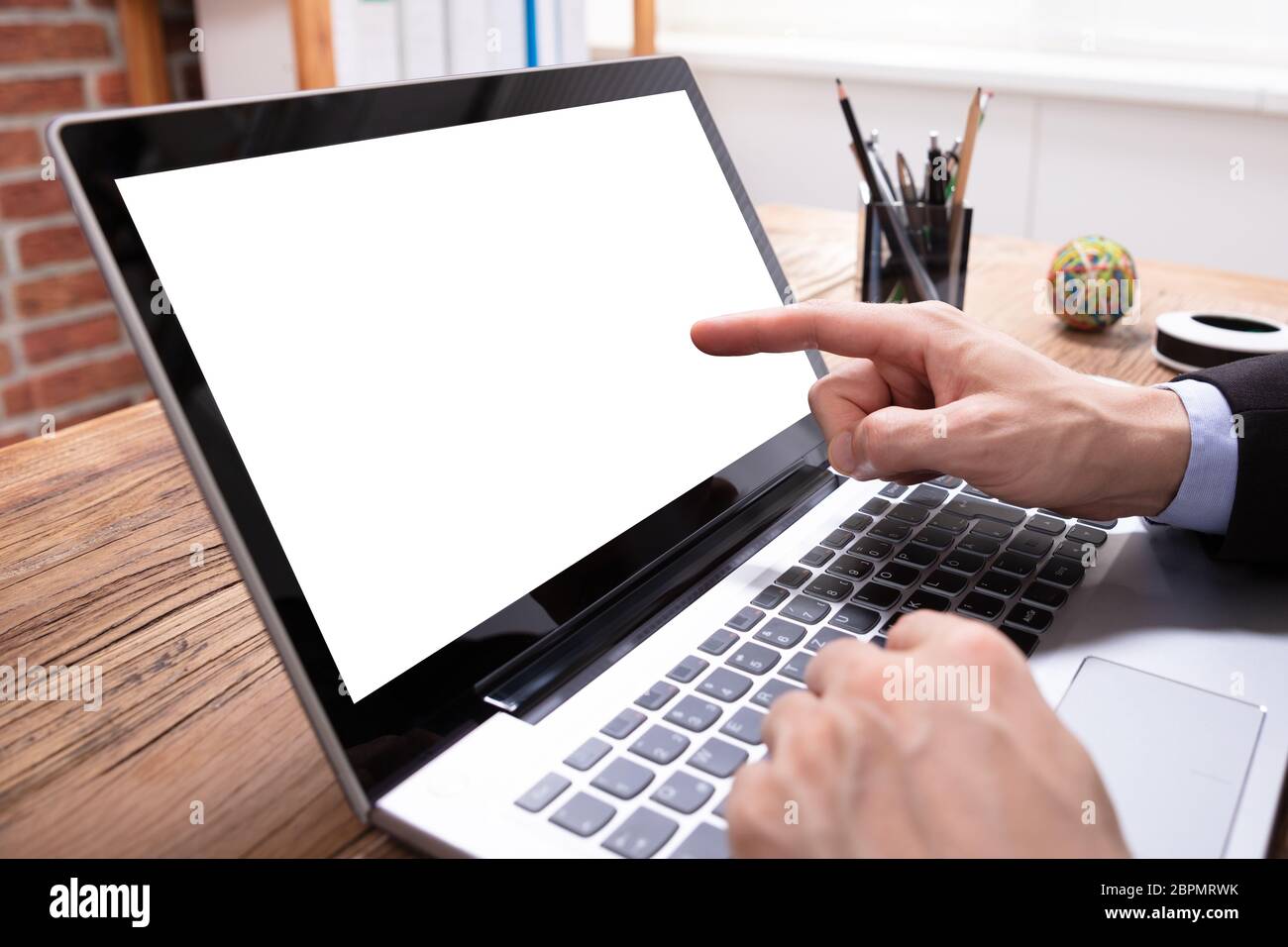 Businessman's Hand Touching Laptop With Blank White Screen Stock Photo ...