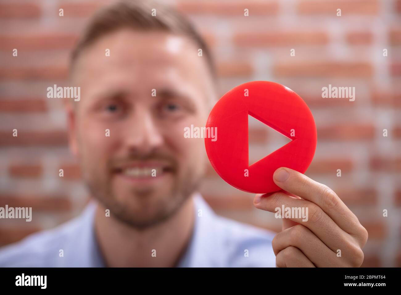 Close-up Of A Happy Businessman's Hand Holding Red Play Button Stock ...