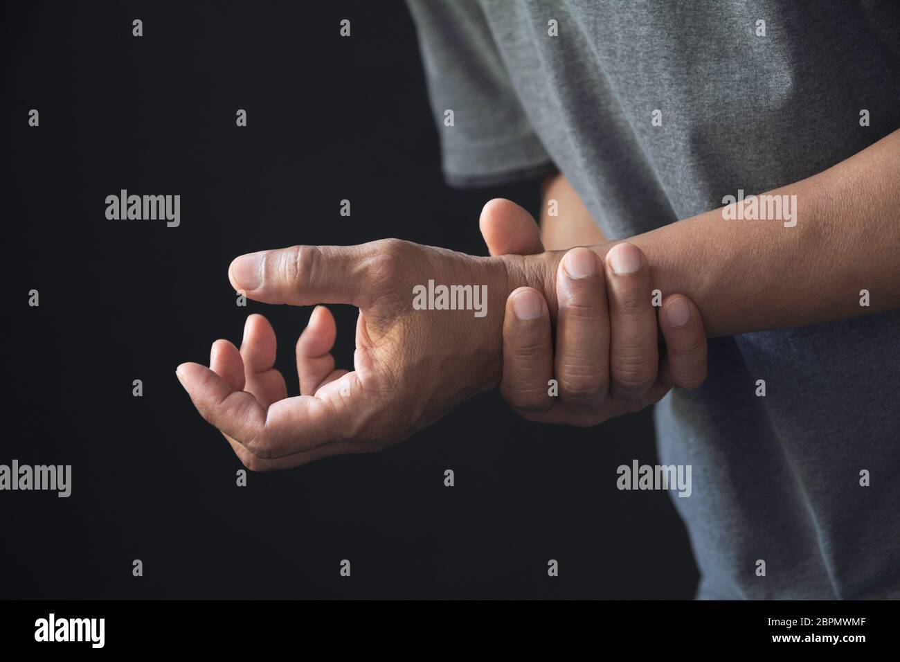 Man holding his wrist. Pain in a man wrist. Man massaging painful wrist ...