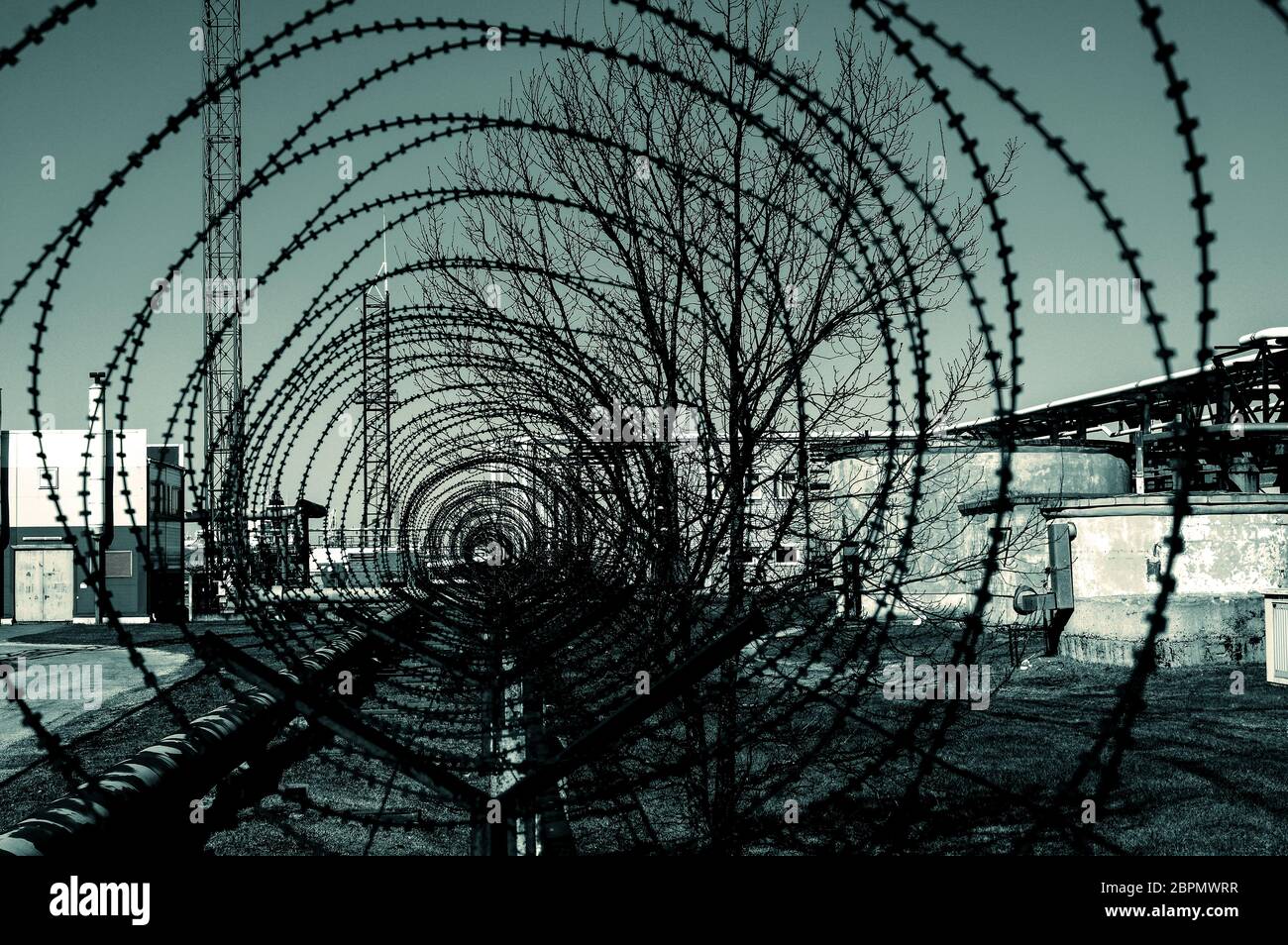 Barbed wire fences in industrial area Stock Photo - Alamy