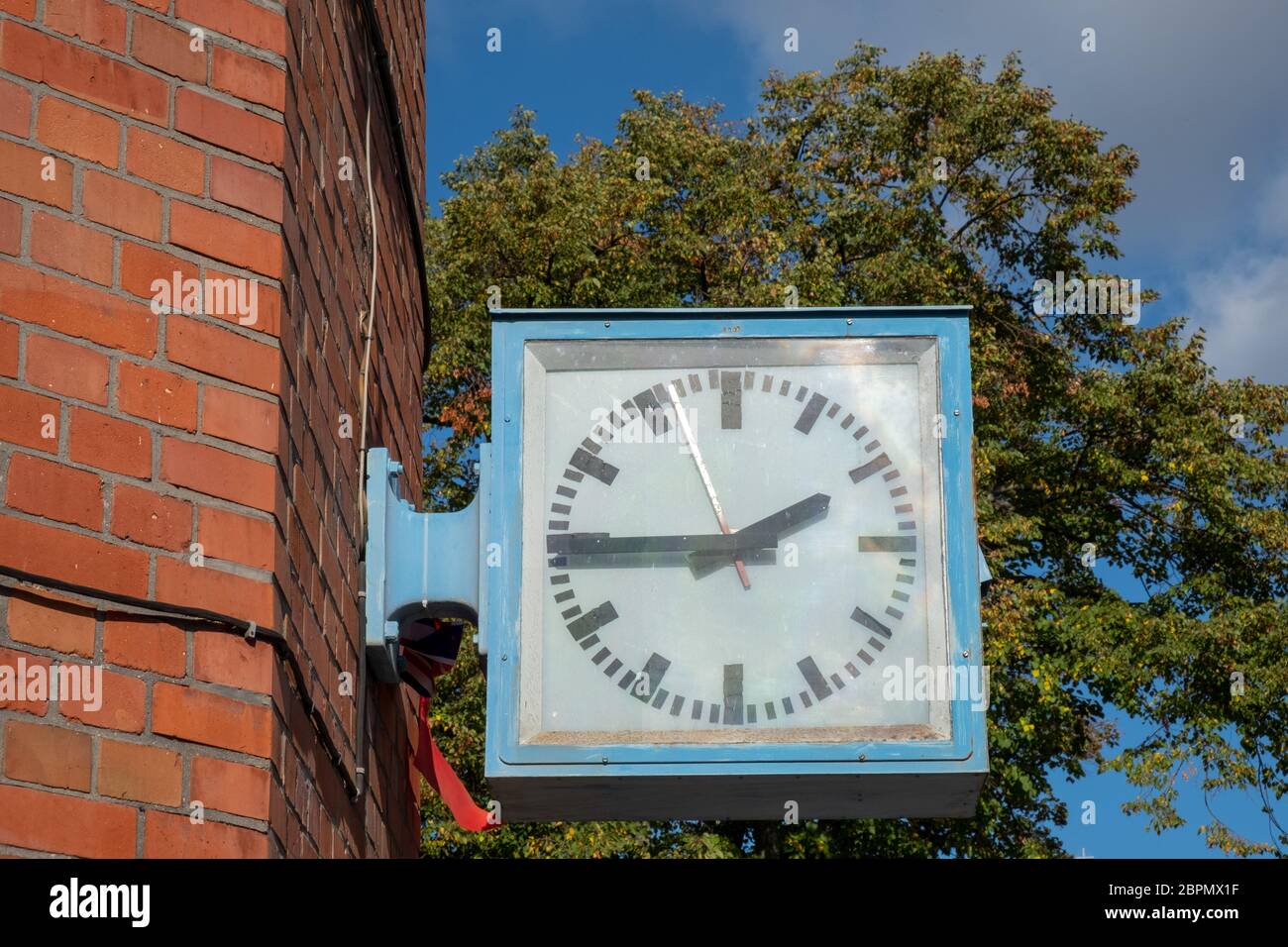a station clock on a brick house Stock Photo - Alamy