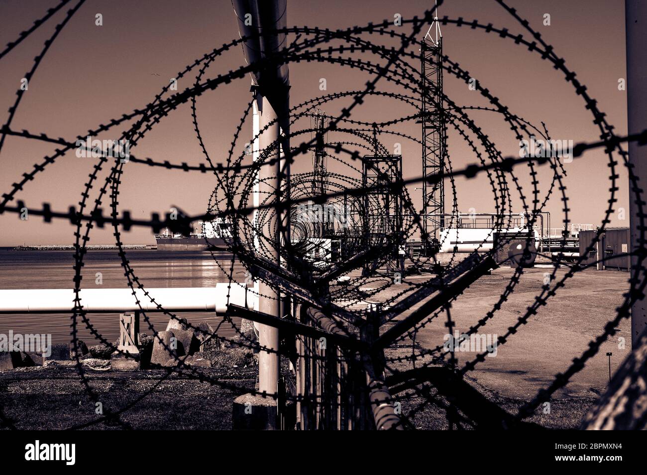 Barbed wire fences in industrial area Stock Photo - Alamy