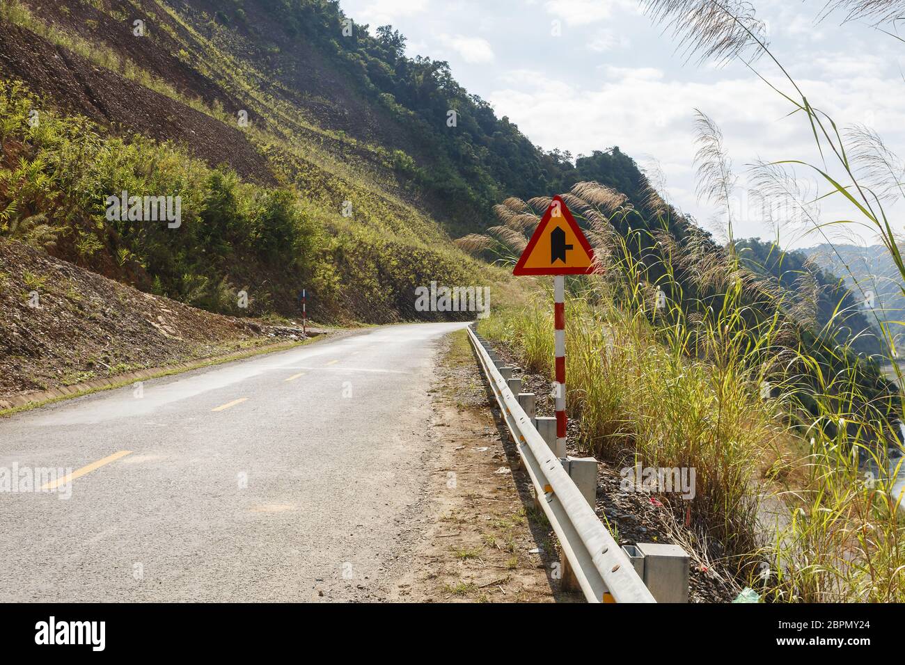 Side road ahead. Road sign on the mountain road in Vietnam Stock Photo ...