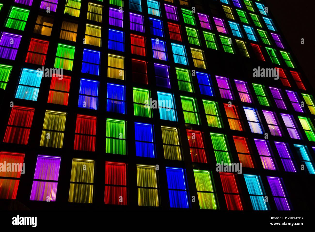 Colored windows texture. Windows illuminated by neon lights background ...