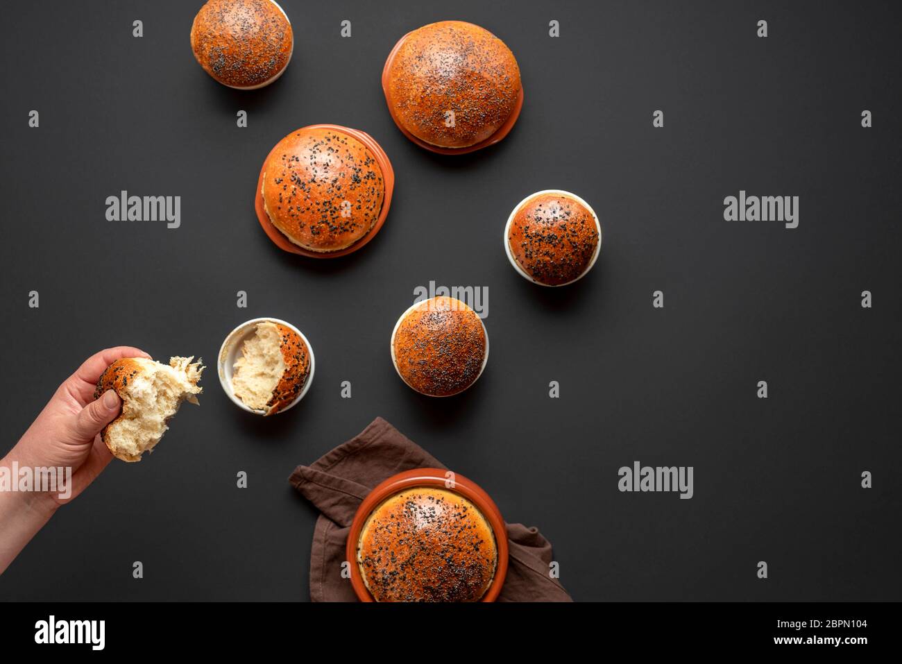 Freshly baked sourdough bread buns top view. White bread in ceramic ...