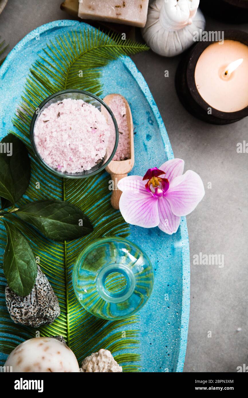 Spa and wellness. Spa products in natural setting with orchid flower ...