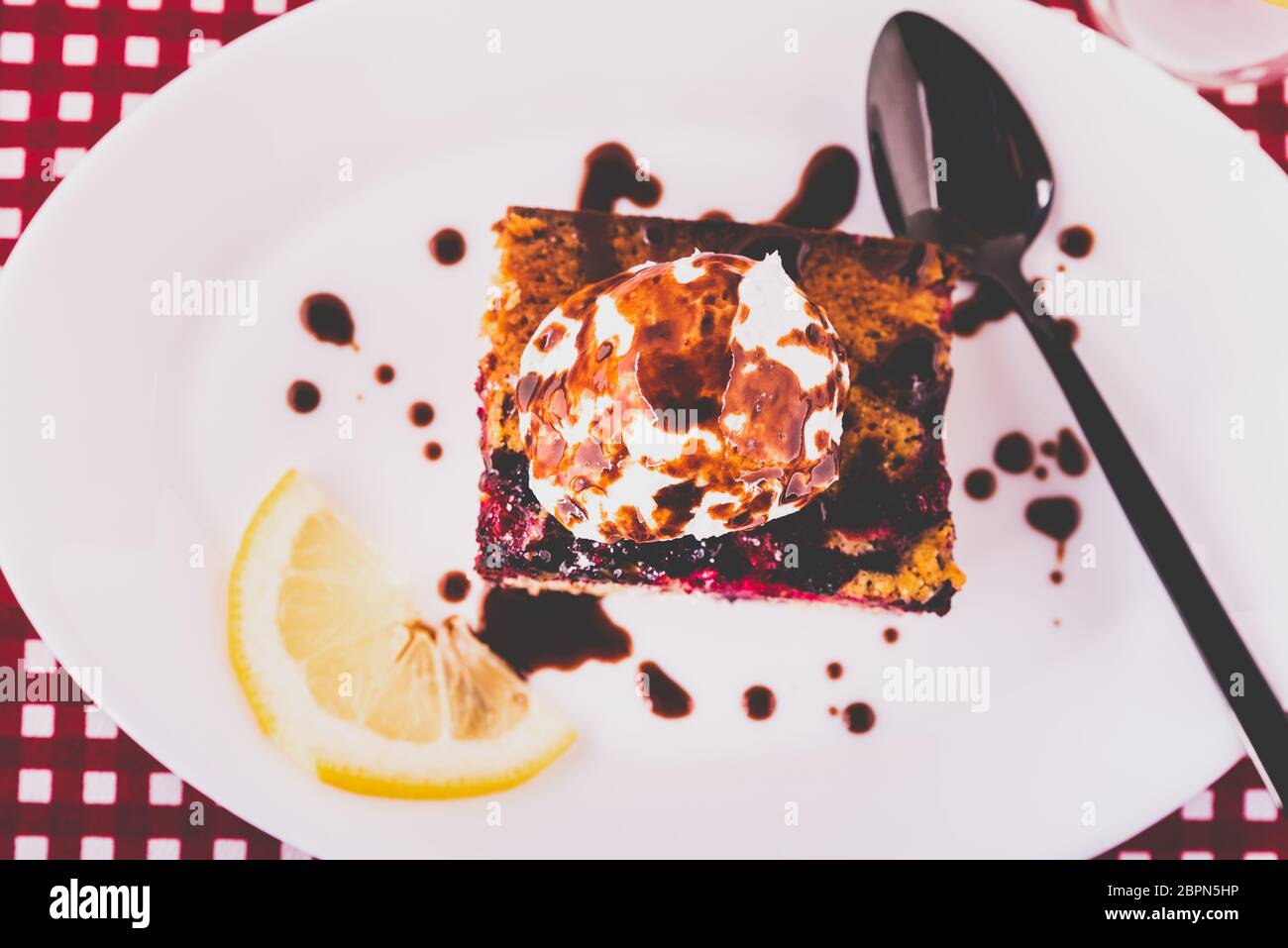 Homemade cake with forest fruit served on a plate with a glass of ...