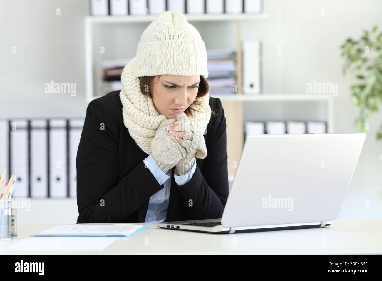 Freezing in a cold office hi-res stock photography and images - Alamy