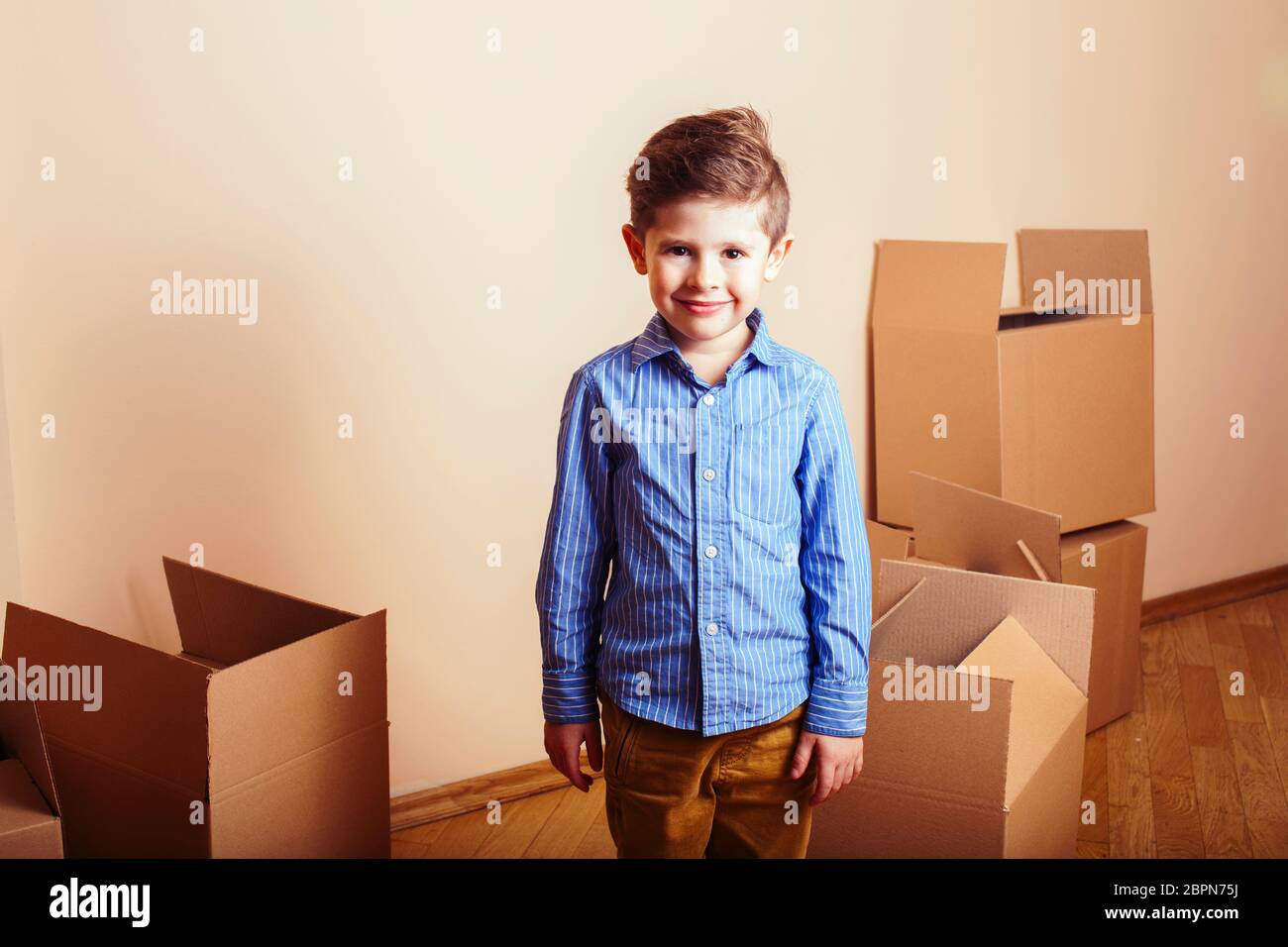 little cute boy in empty room, move to new house. home alone among ...