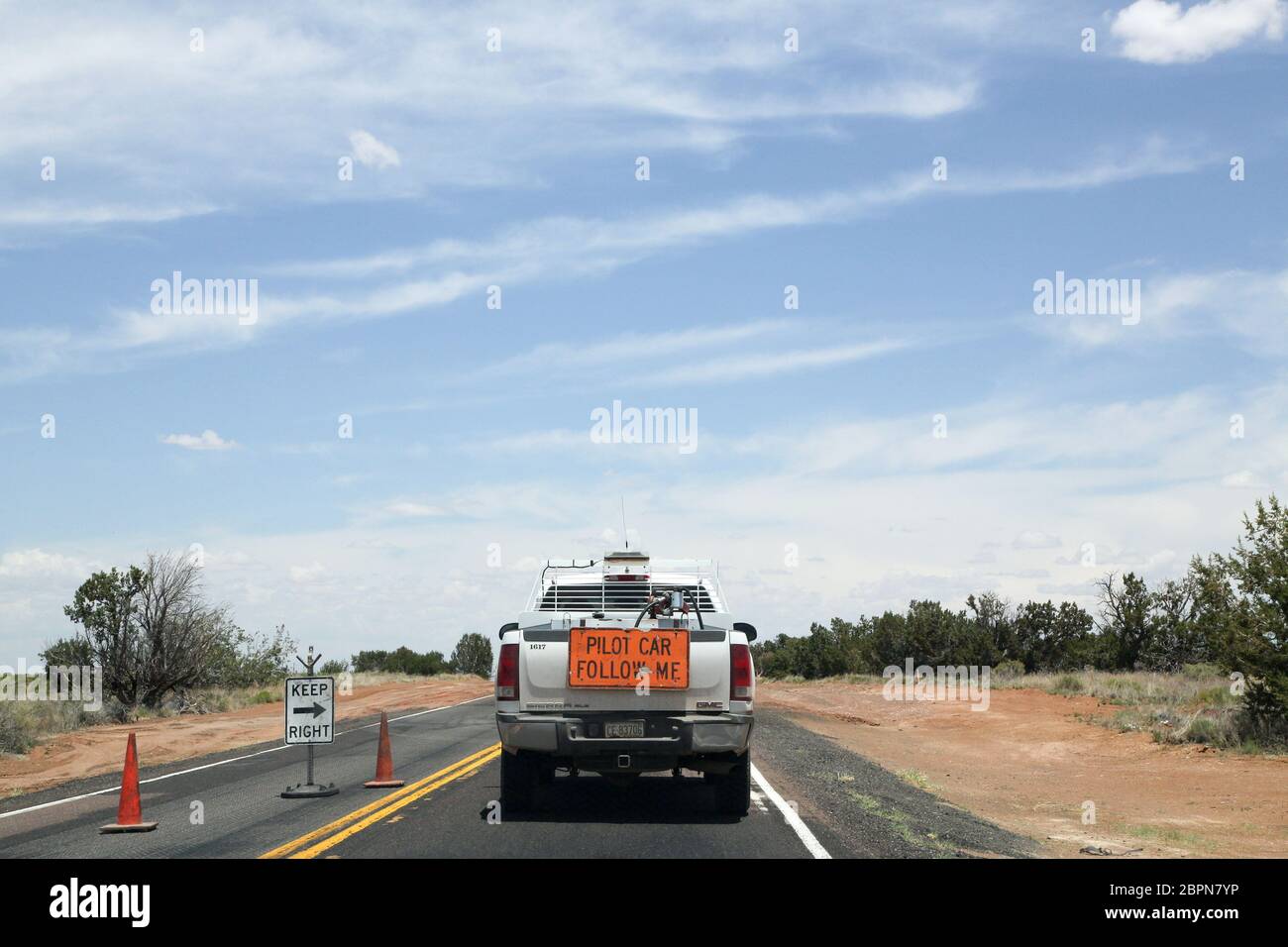 Flag man on highway, New Mexico Stock Photo - Alamy