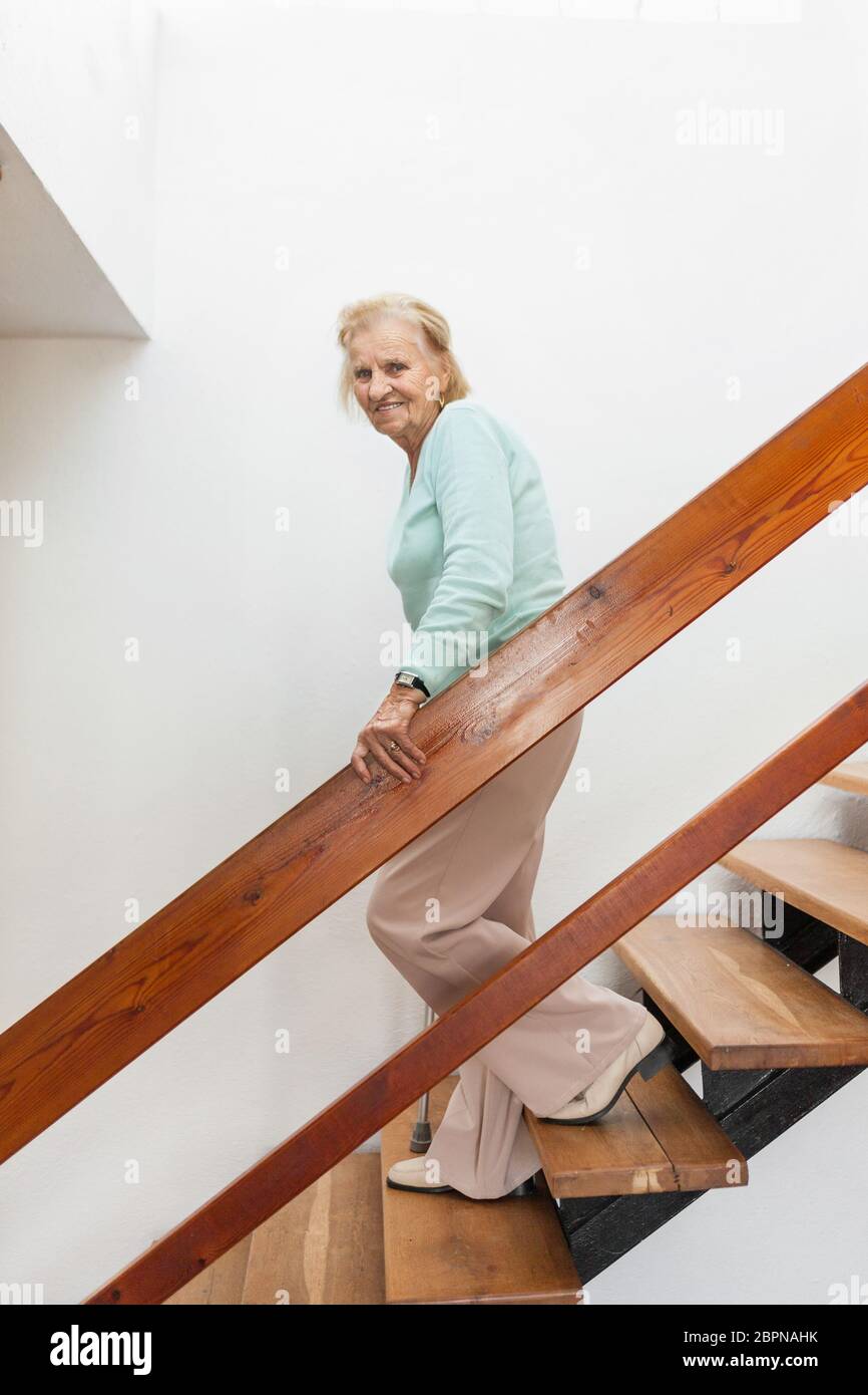 Elderly lady going down stairs hi-res stock photography and images - Alamy