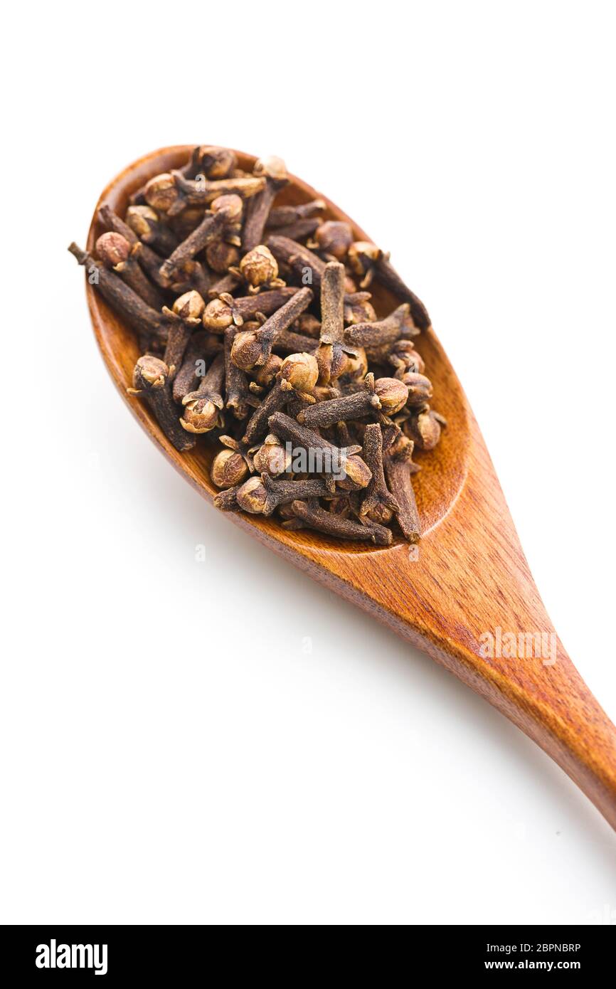 Carnation, dried clove spice in wooden spoon isolated on white ...