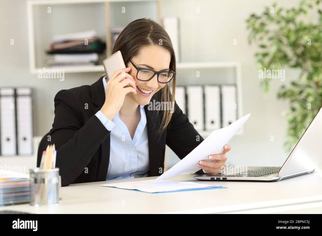 Happy customer calling support service about a paper document at office ...