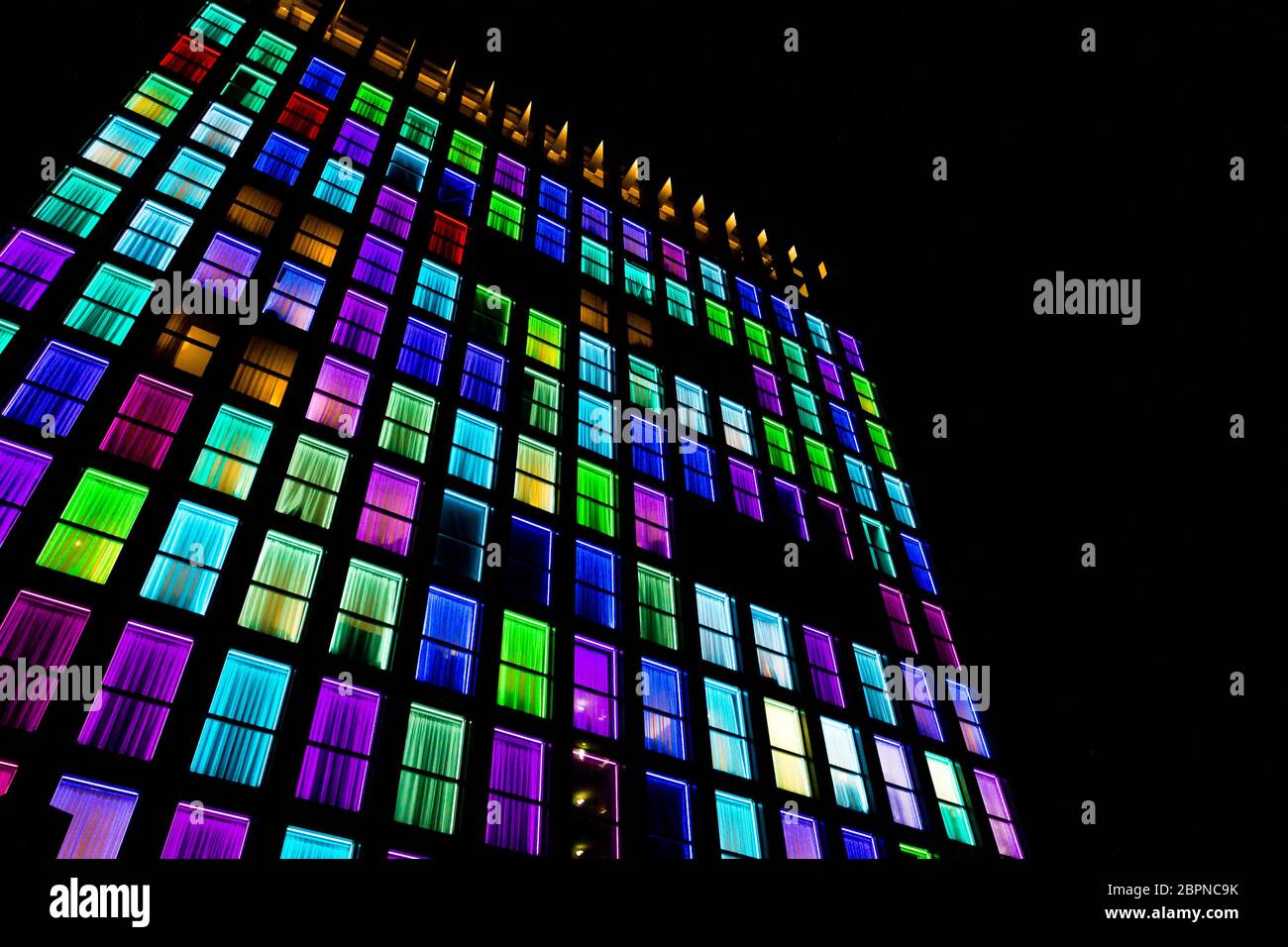 Colored windows texture. Windows illuminated by neon lights background ...