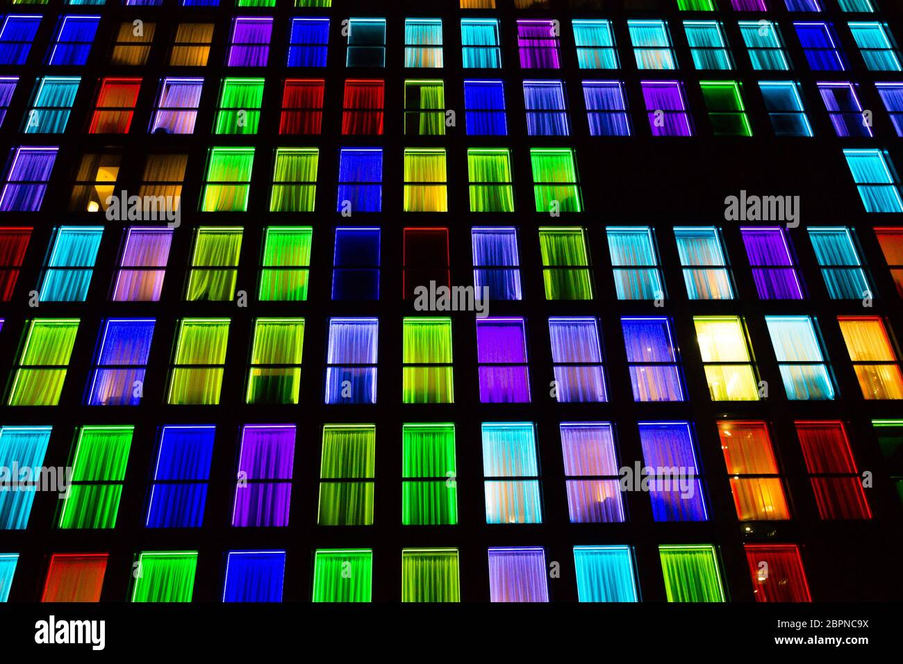 Colored windows texture. Windows illuminated by neon lights background ...