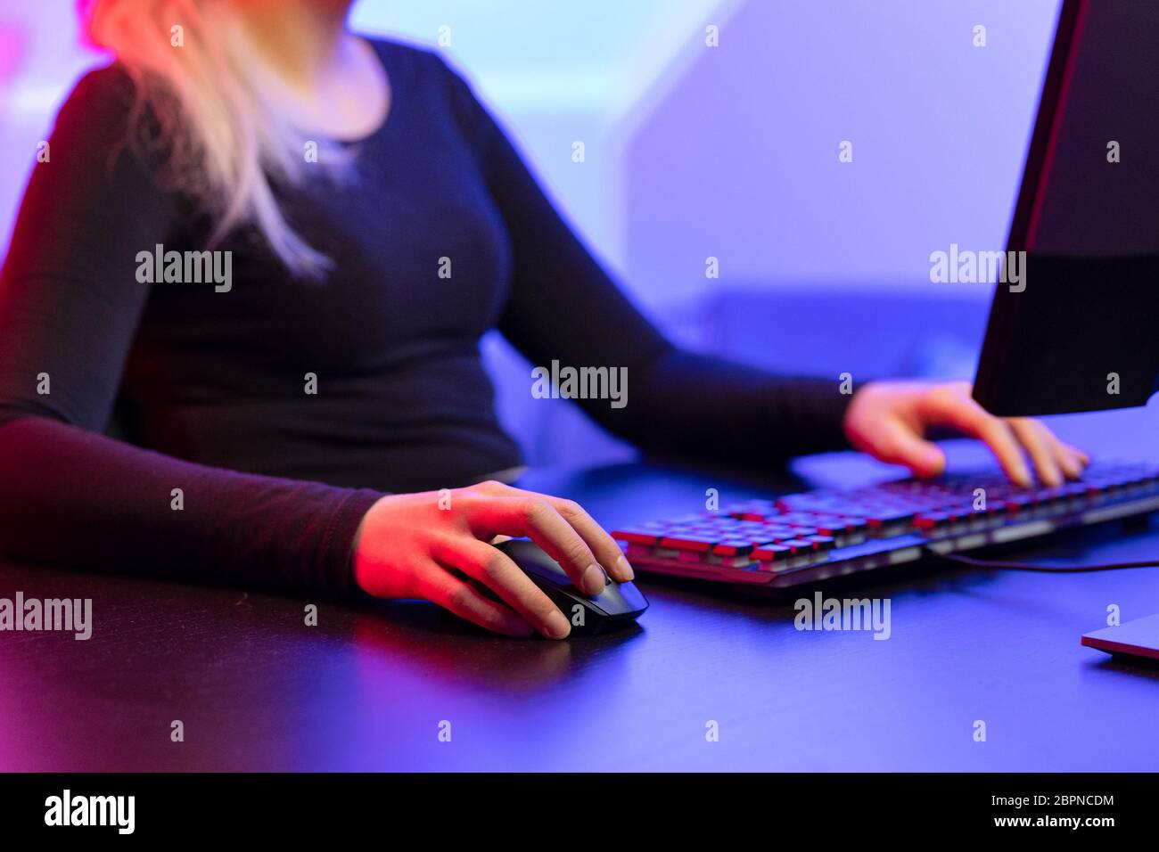 Close-up of Blonde Gamer Girl Playing Online Video Game on Her Personal ...