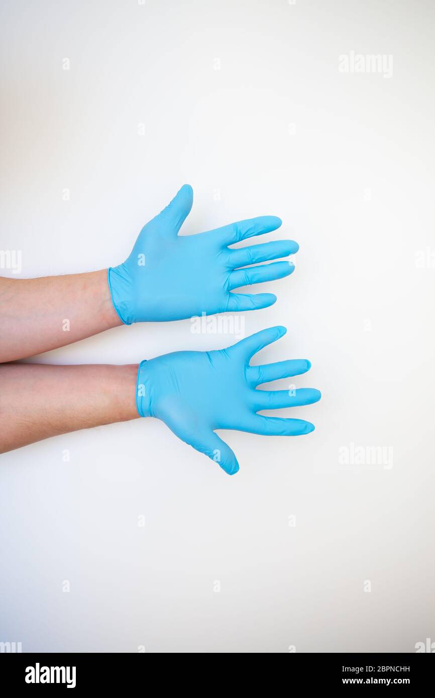 Hands in blue medical disposable gloves show a hand washing pattern ...