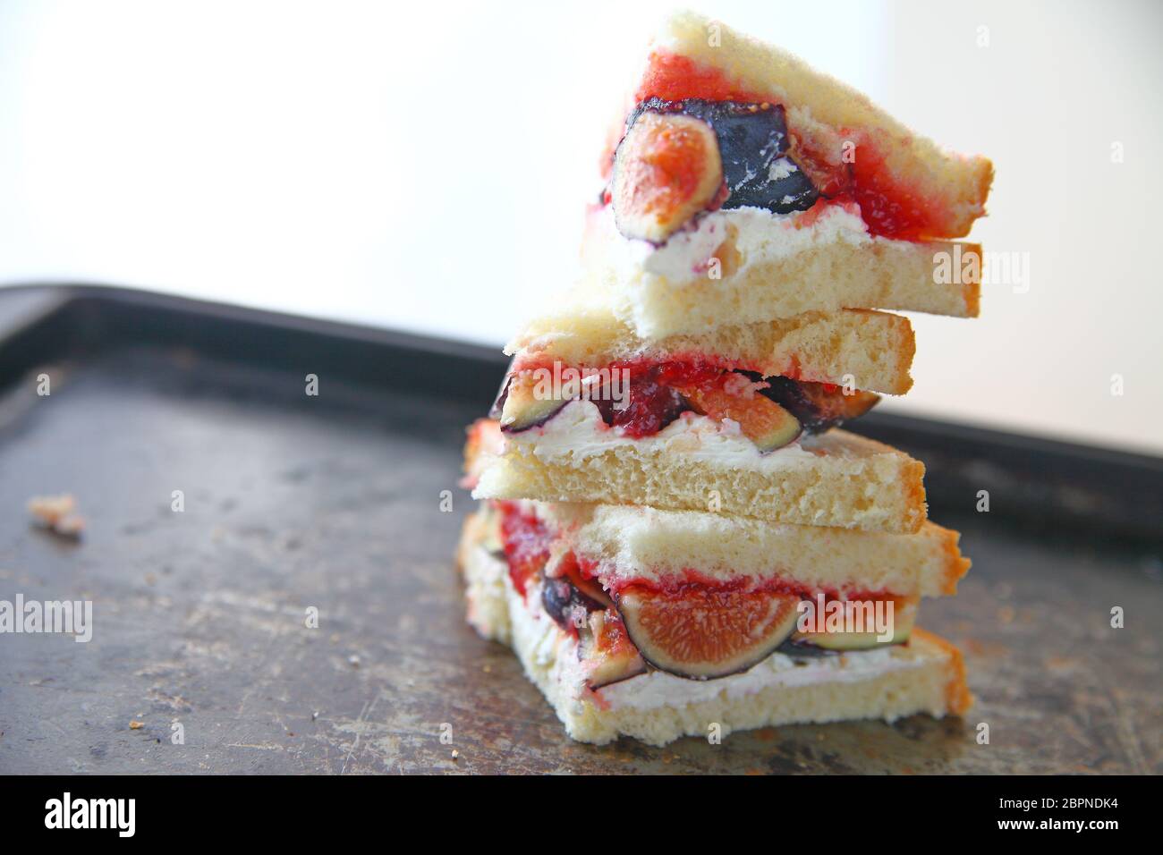 Fresh figs with cream cheese and jam sandwich cut into triangles and ...