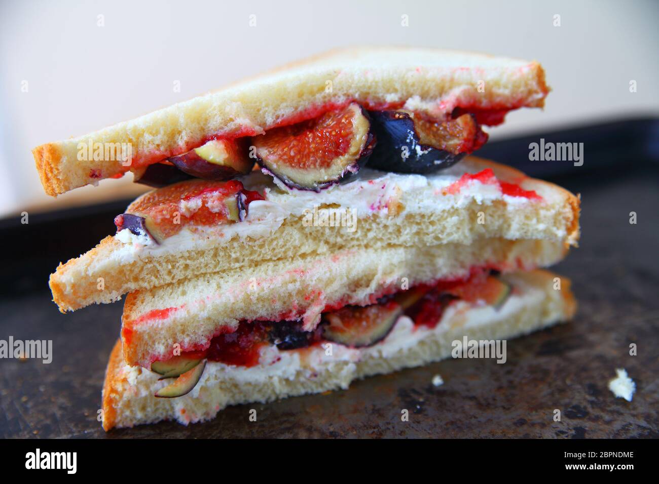 Fruit sandwich with cream cheese and jam, cut in half and stacked Stock ...