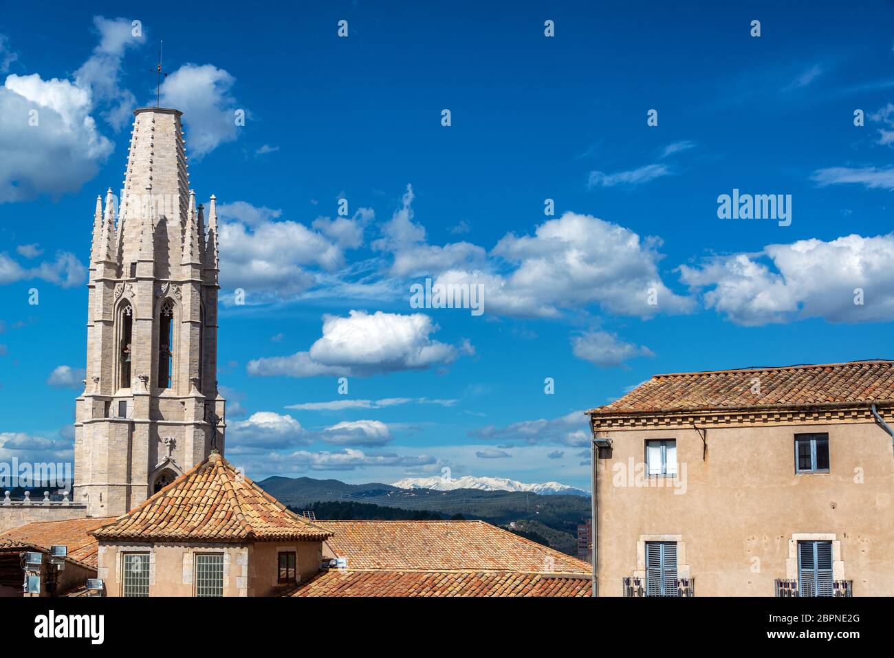 Tower of the Church of St. Felix with the Pyrenees Mountains in the ...