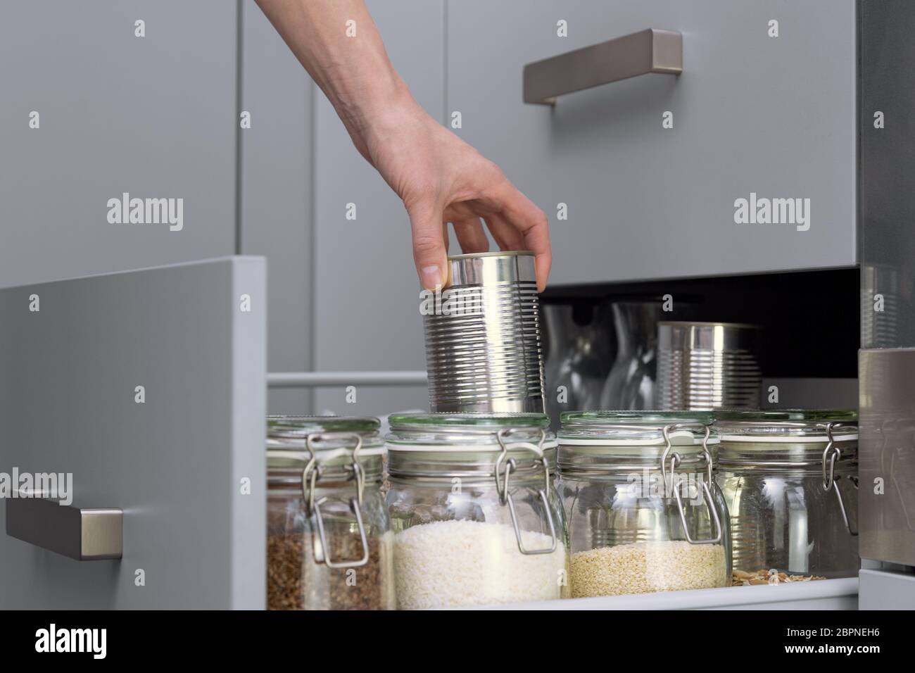 Women picking an item from storage hutch. Smart kitchen organization ...