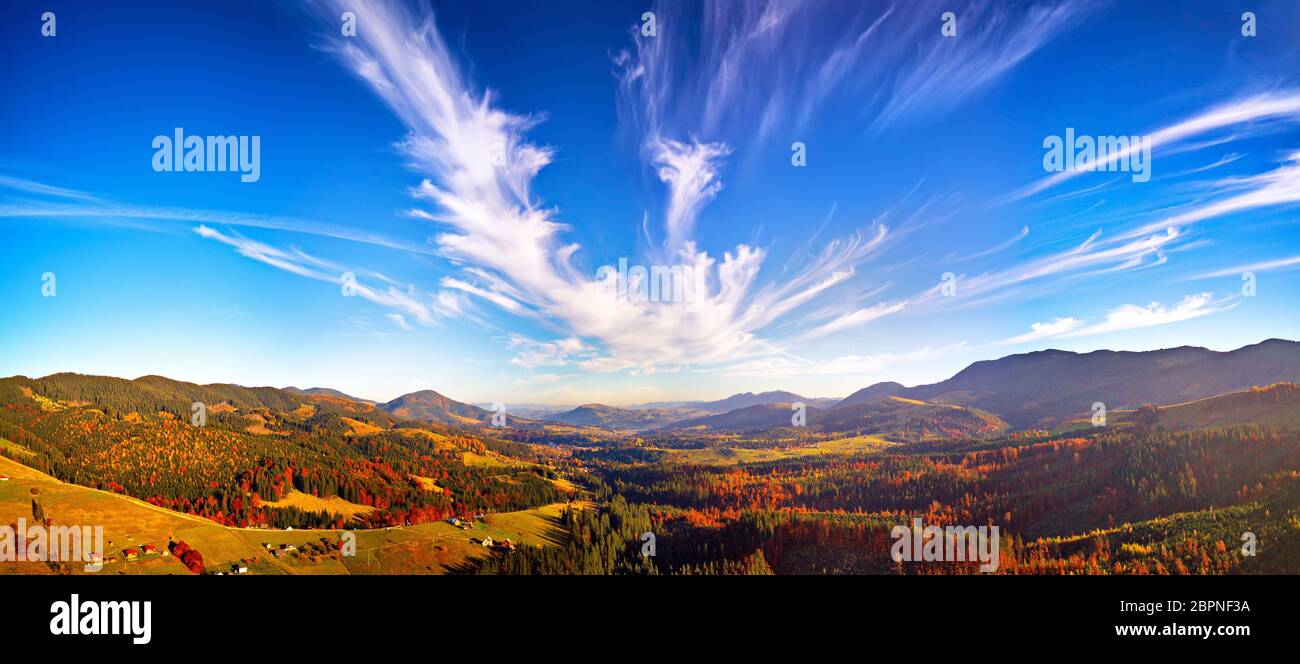 Aerial panoramic view of autumn mountain valley. Sunlight on the hills ...