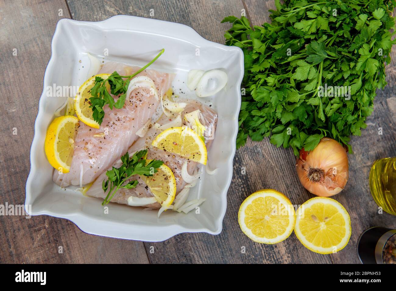 Fresh fish, a raw cod fillets with addition of herbs and lemon Stock ...