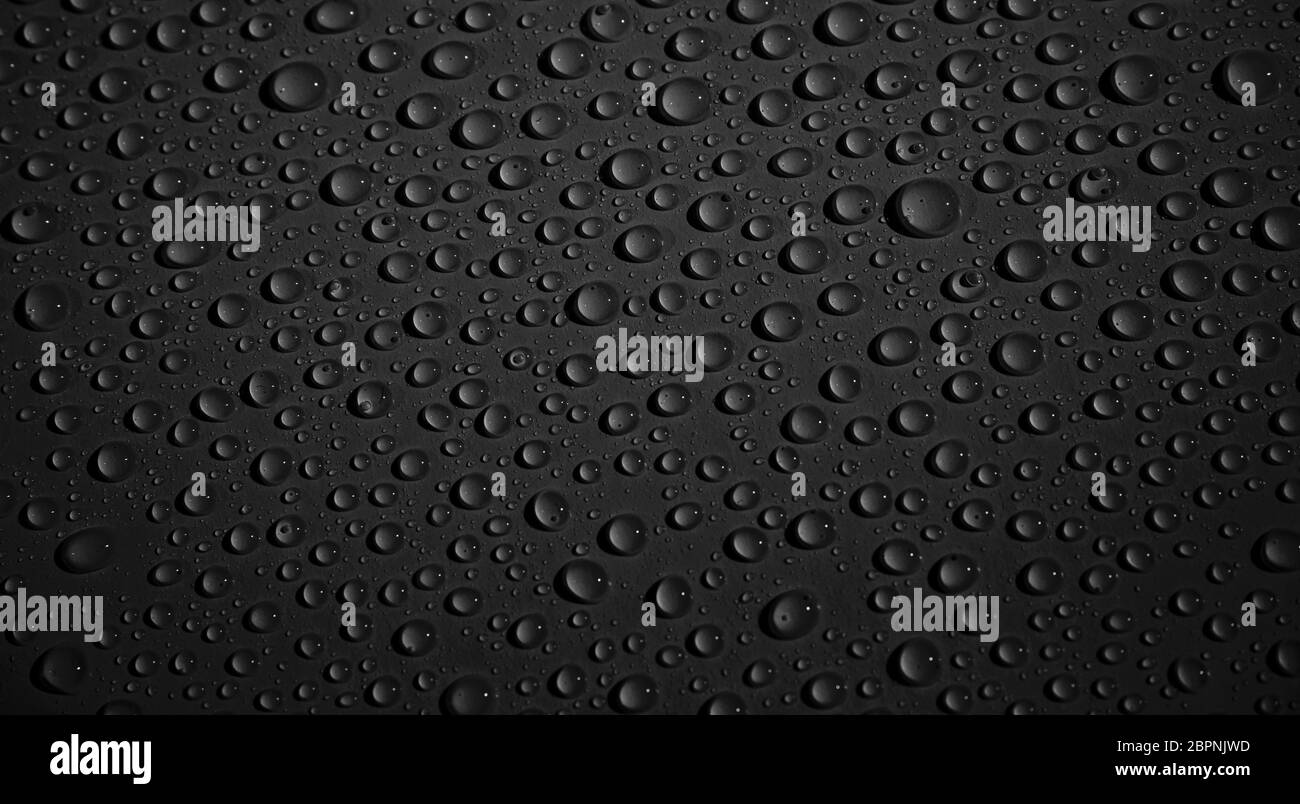 Fresh water drops on black background texture Stock Photo - Alamy