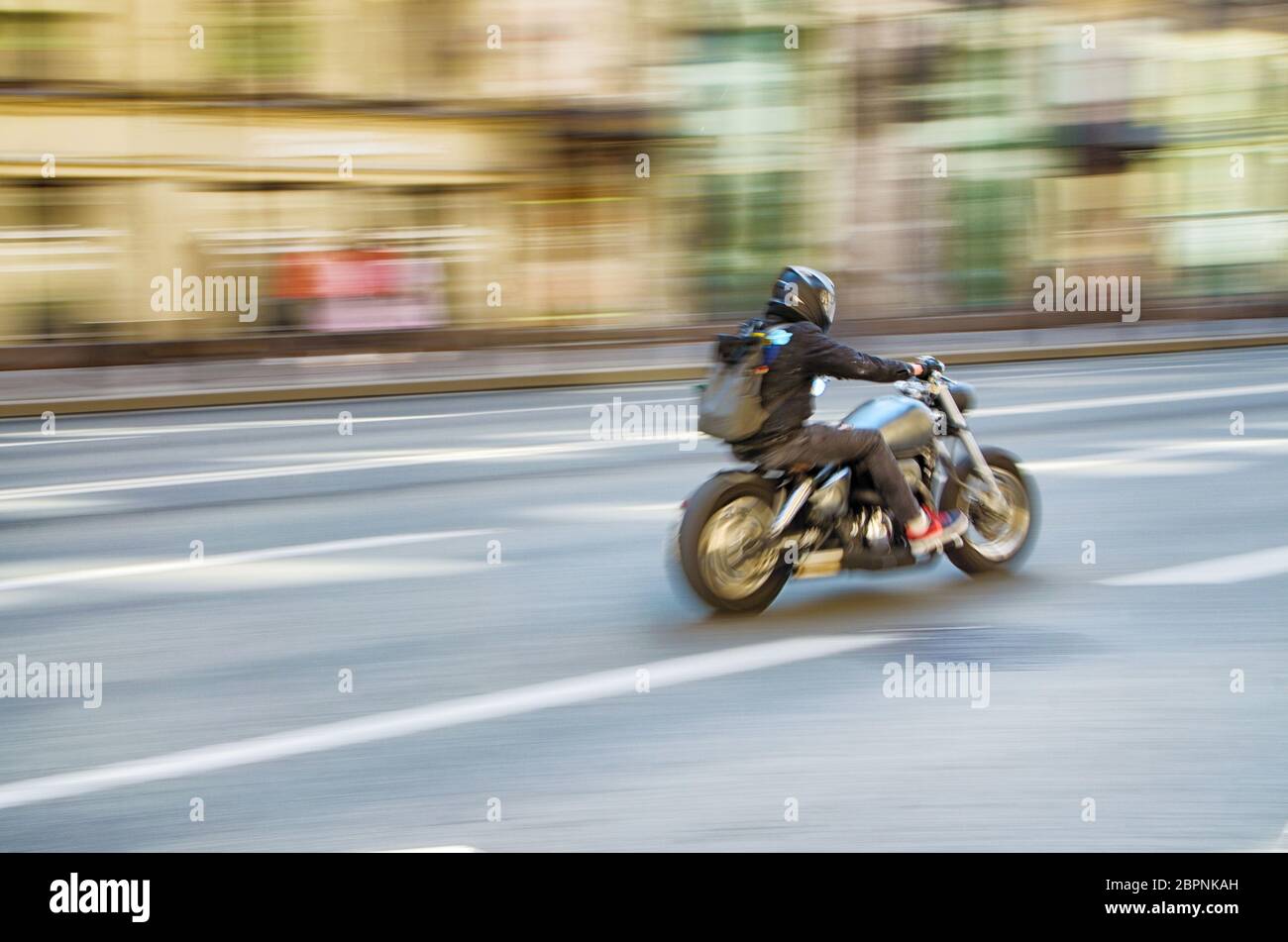 Fast motorcycle riding on a city street Stock Photo - Alamy
