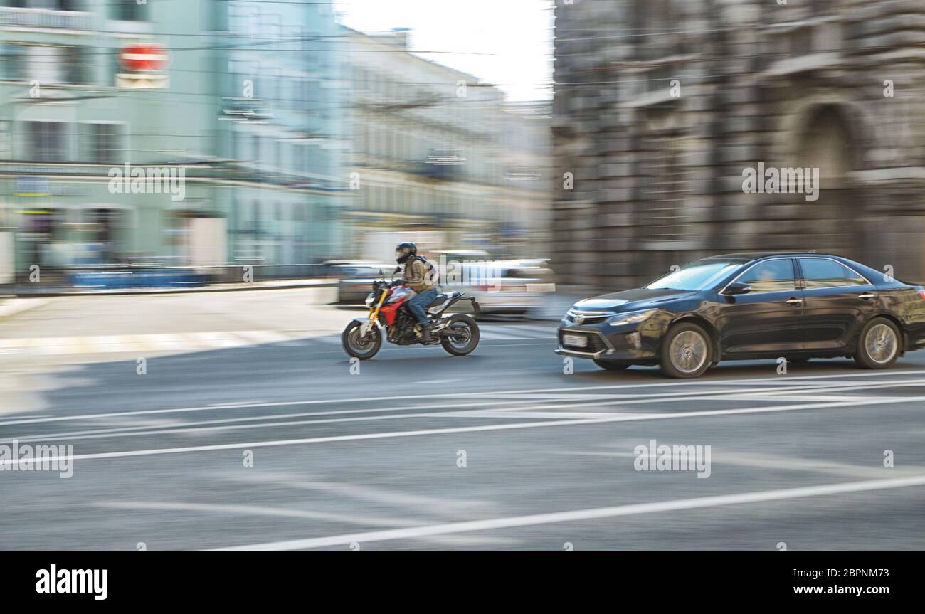 Fast motorcycle riding on a city street Stock Photo - Alamy