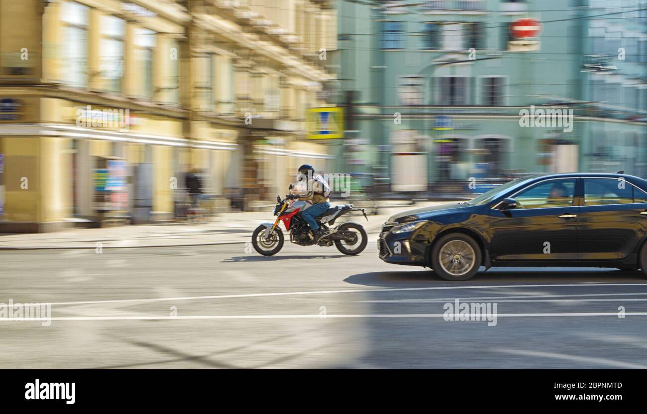 Fast motorcycle riding on a city street Stock Photo - Alamy