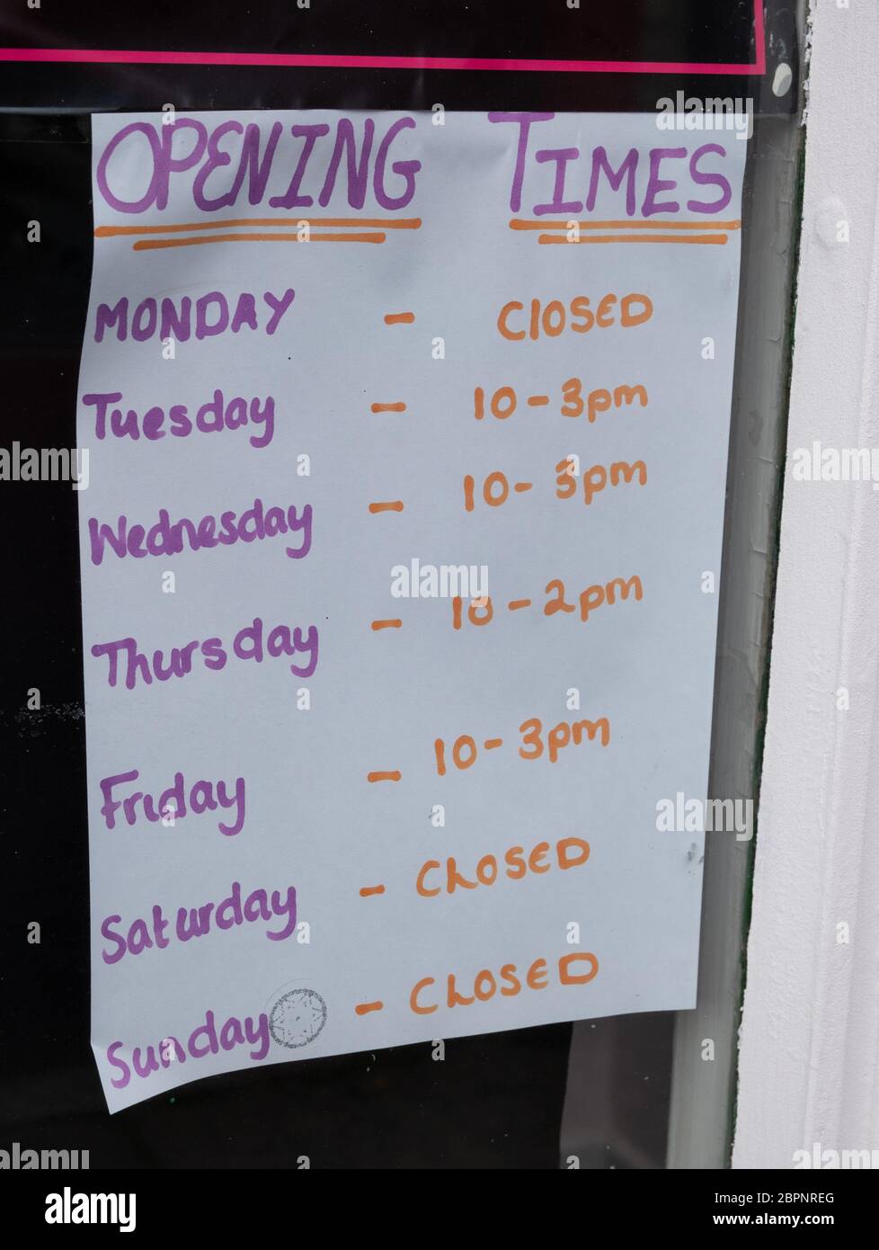 paper notice indicating opening hours of cafe inBirkenhead Wirral ...