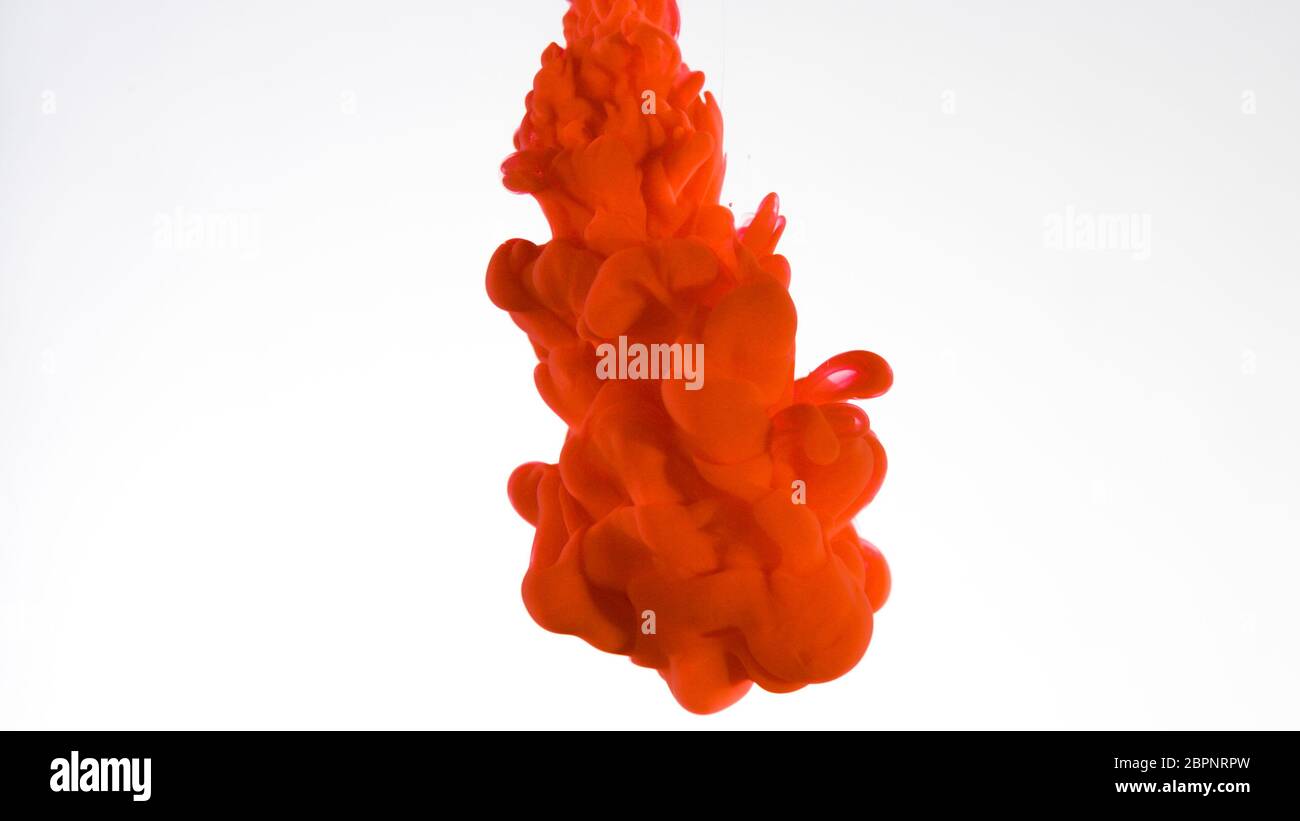 Cloud of red color ink in water isolated on white. Abstract design and ...