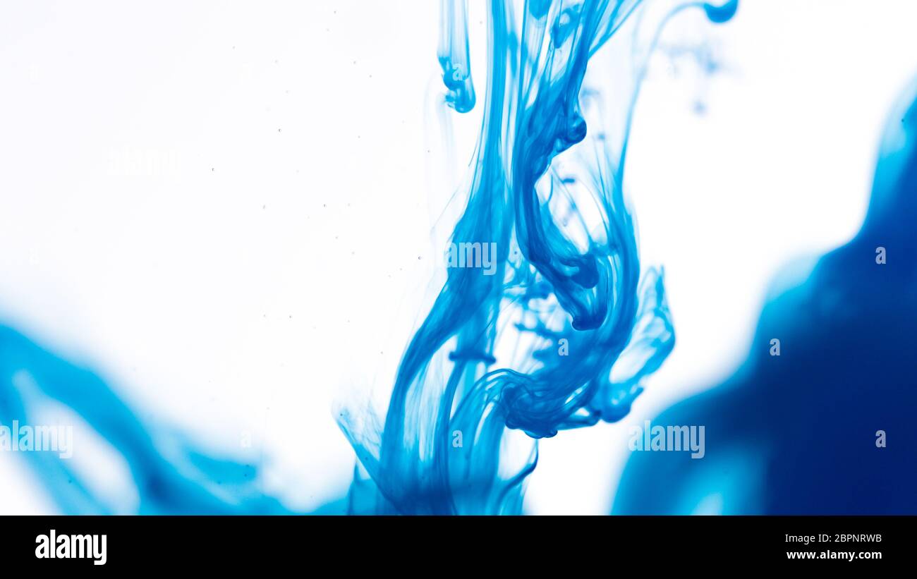 Cloud of blue color ink in water isolated on white. Abstract design and ...