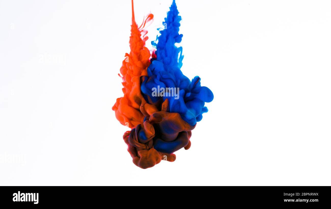 Cloud of color ink in water isolated on white. Blue and red abstract ...