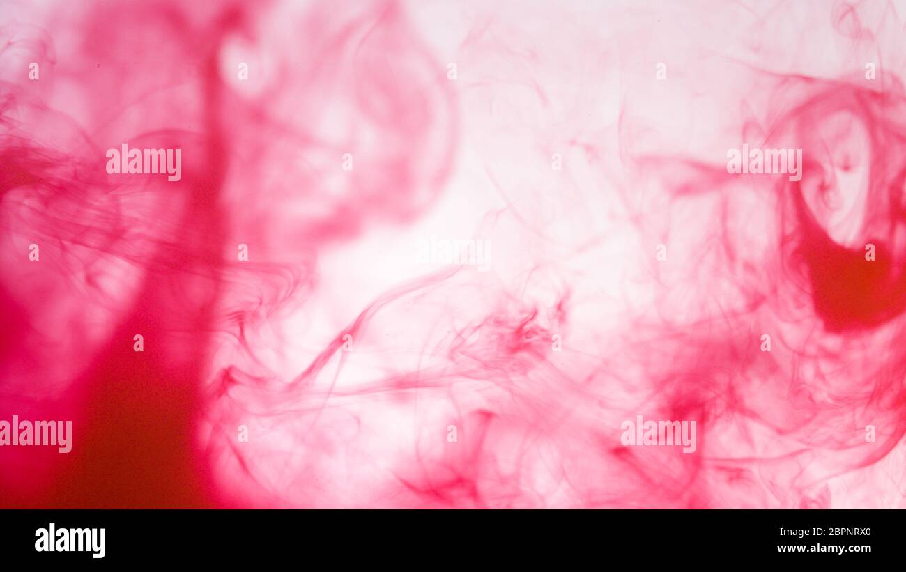 Cloud of red color ink in water isolated on white. Abstract design and ...