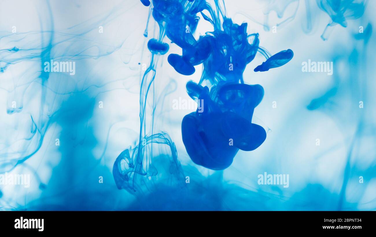 Cloud of blue color ink in water isolated on white. Abstract design and ...