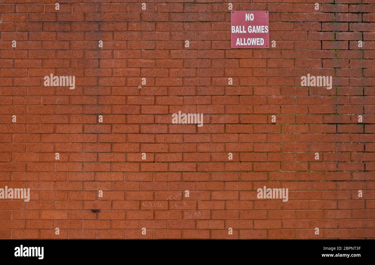 brick wall with no ball games allowed sign in Birkenhead Wirral January ...