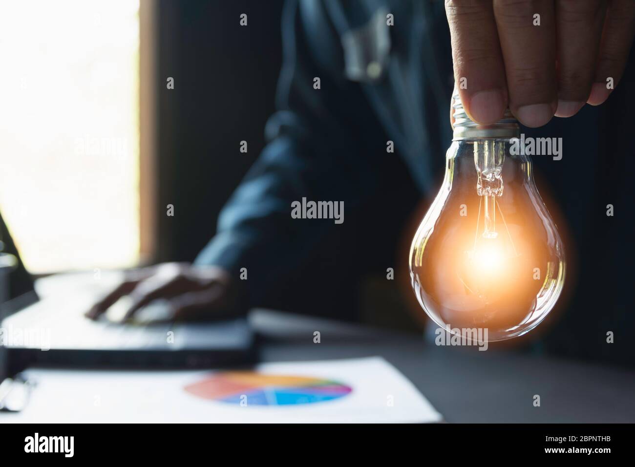 Hand of male holding a light bulb and copy space for accounting, ideas ...