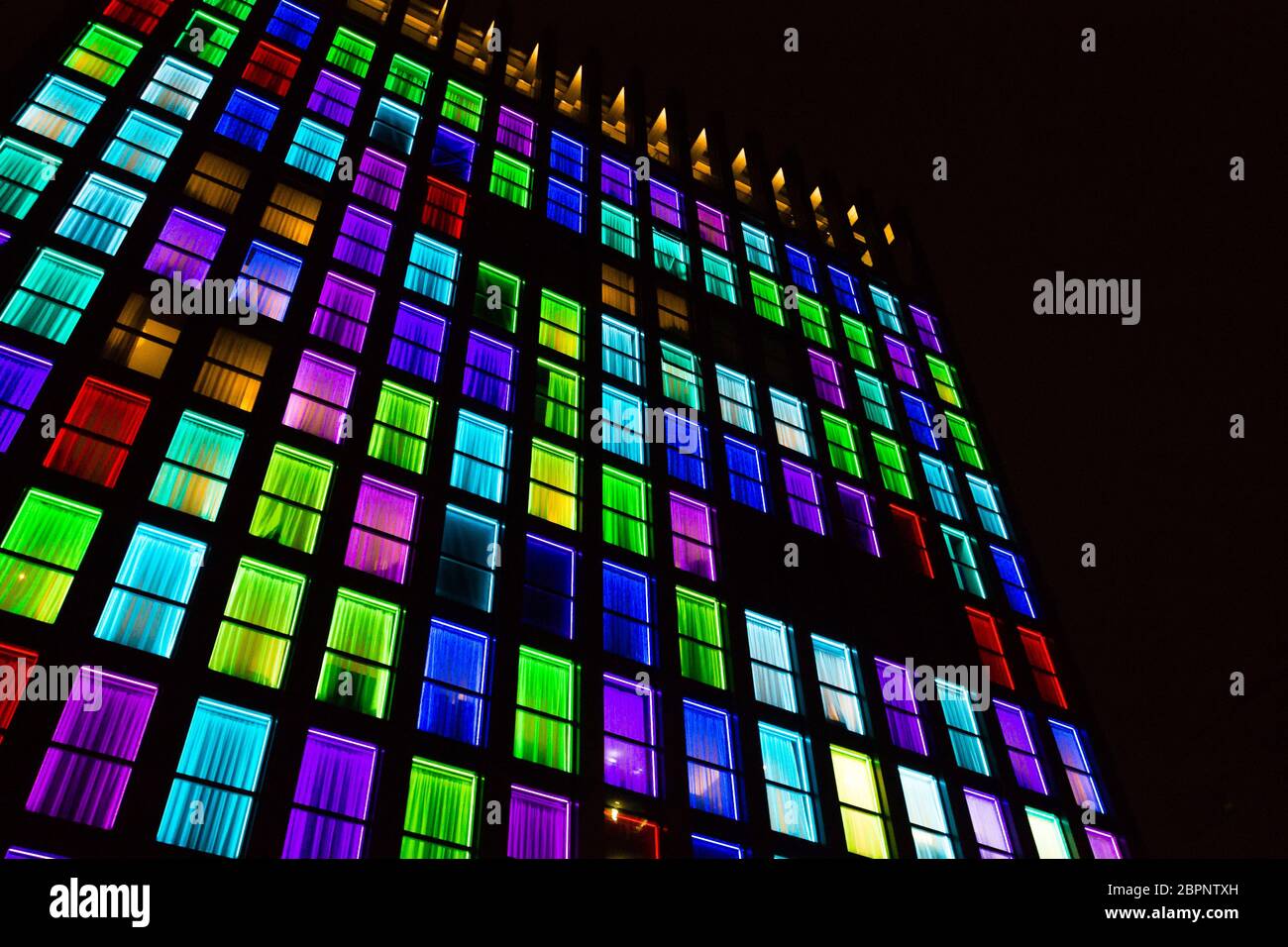 Colored windows texture. Windows illuminated by neon lights background ...