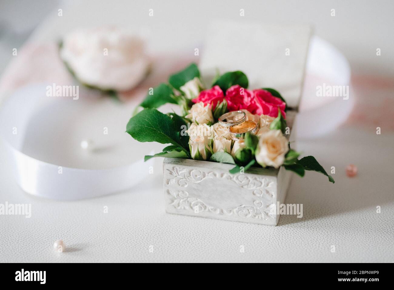 wedding rings with a wedding decor Stock Photo - Alamy