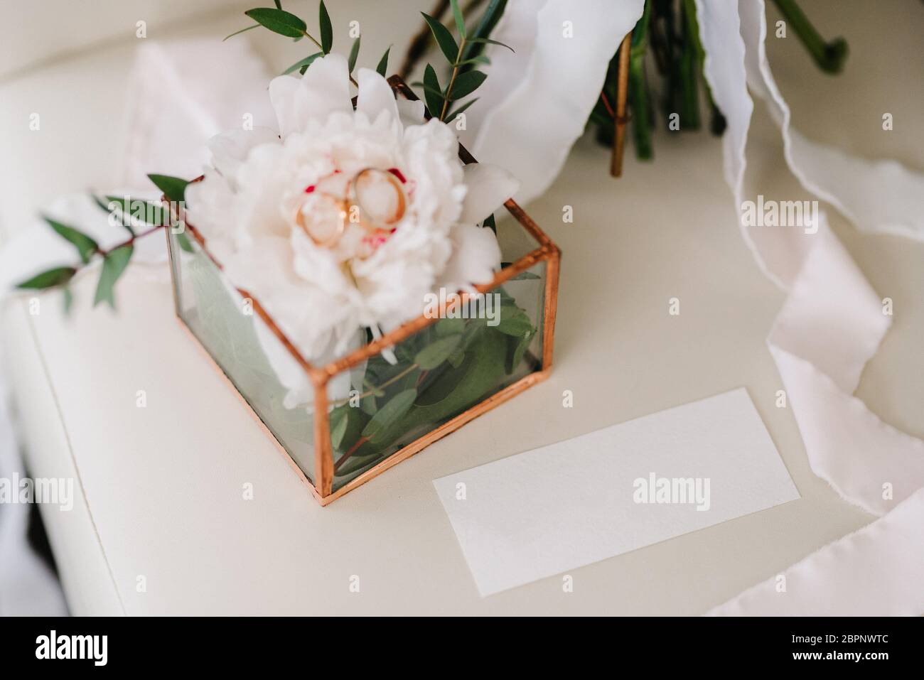 wedding rings with a wedding decor Stock Photo - Alamy