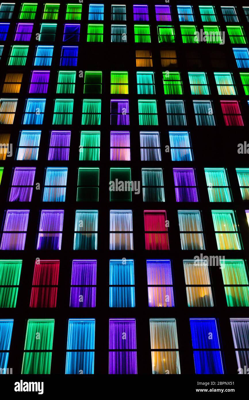 Colored windows texture. Windows illuminated by neon lights background ...
