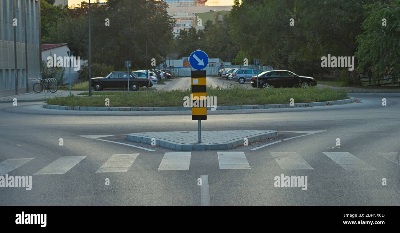 Crossroad with traffic sign and parking lot in background Stock Photo ...