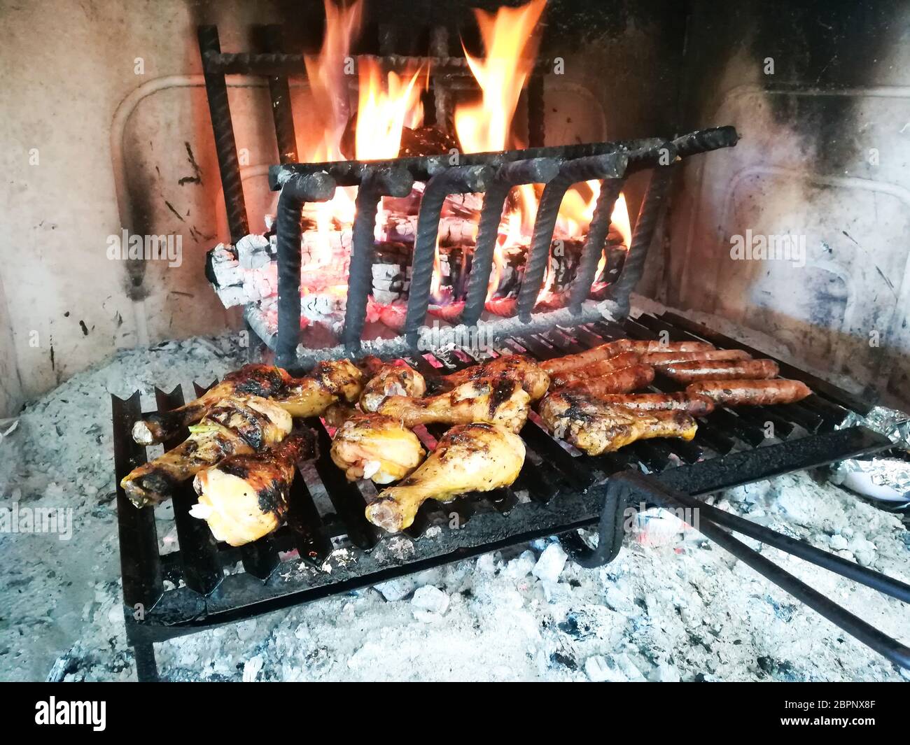 Grilled meat cooked on fireplace Stock Photo - Alamy