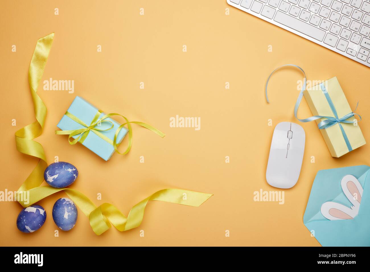 Colored easter eggs, gift box, computer keyboard and mouse, blank sheet ...