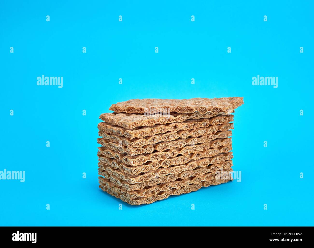 A stack of rectangular snack bars on a blue background, copy space ...