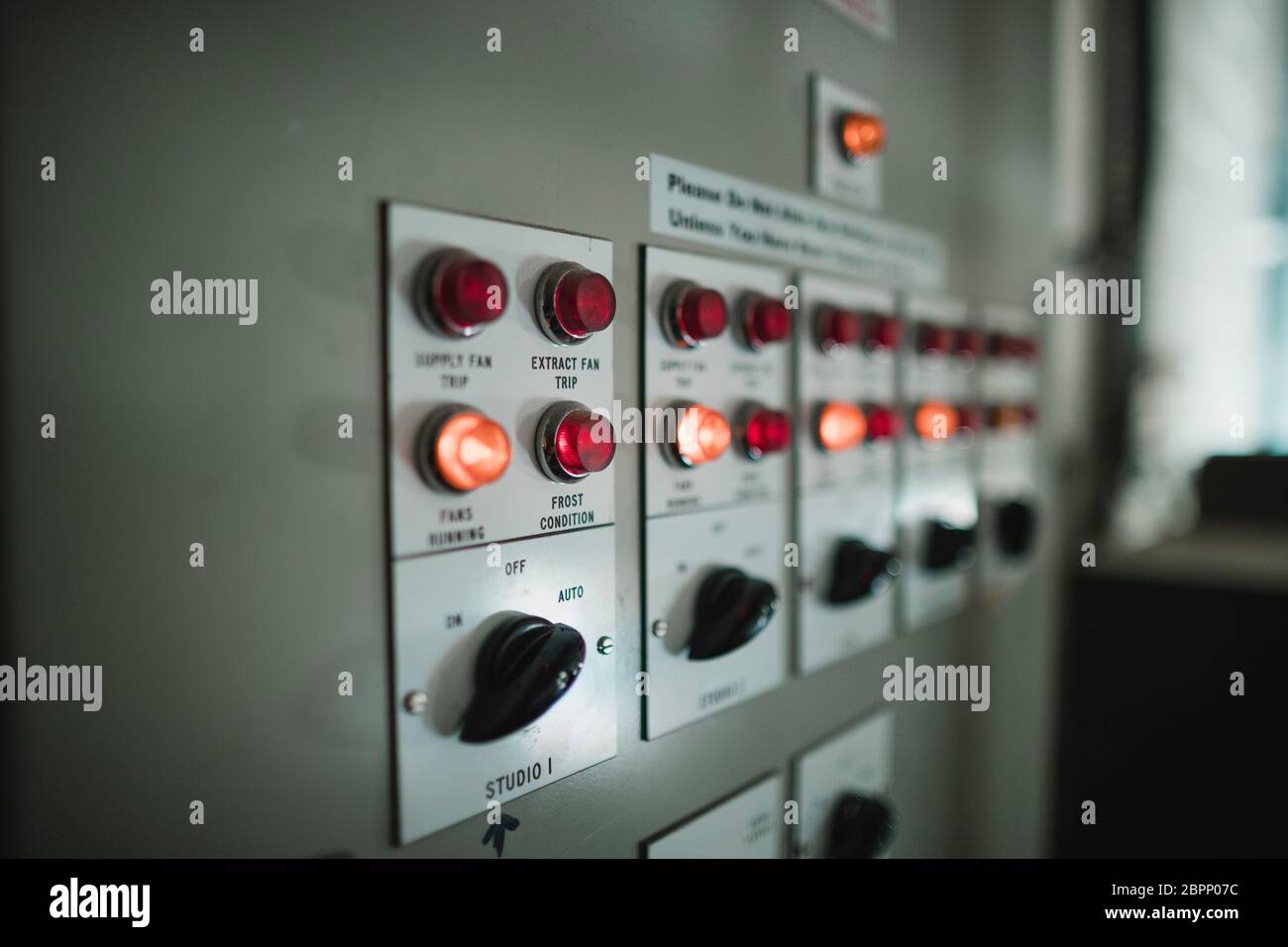 Close up shot of switches and indication lights on an electric board ...