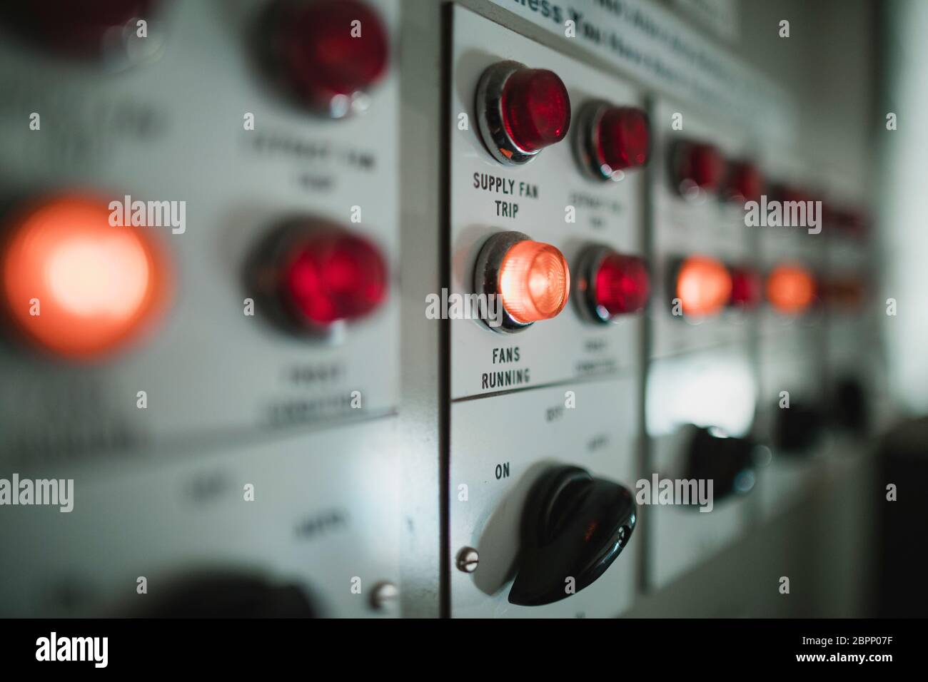 Close up shot of switches and indication lights on an electric board ...