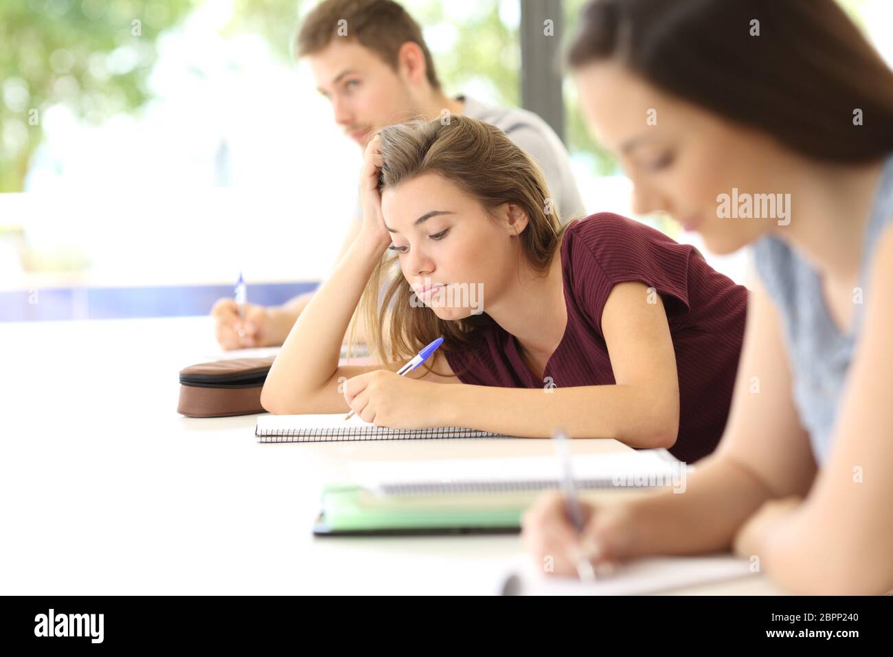 Uninterested student drawing during a class in a classroom Stock Photo ...